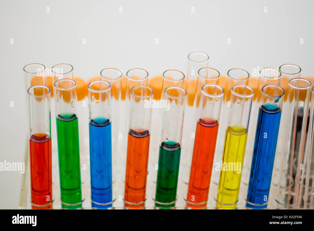 Rows of colorful test tubes on lab table Stock Photo - Alamy