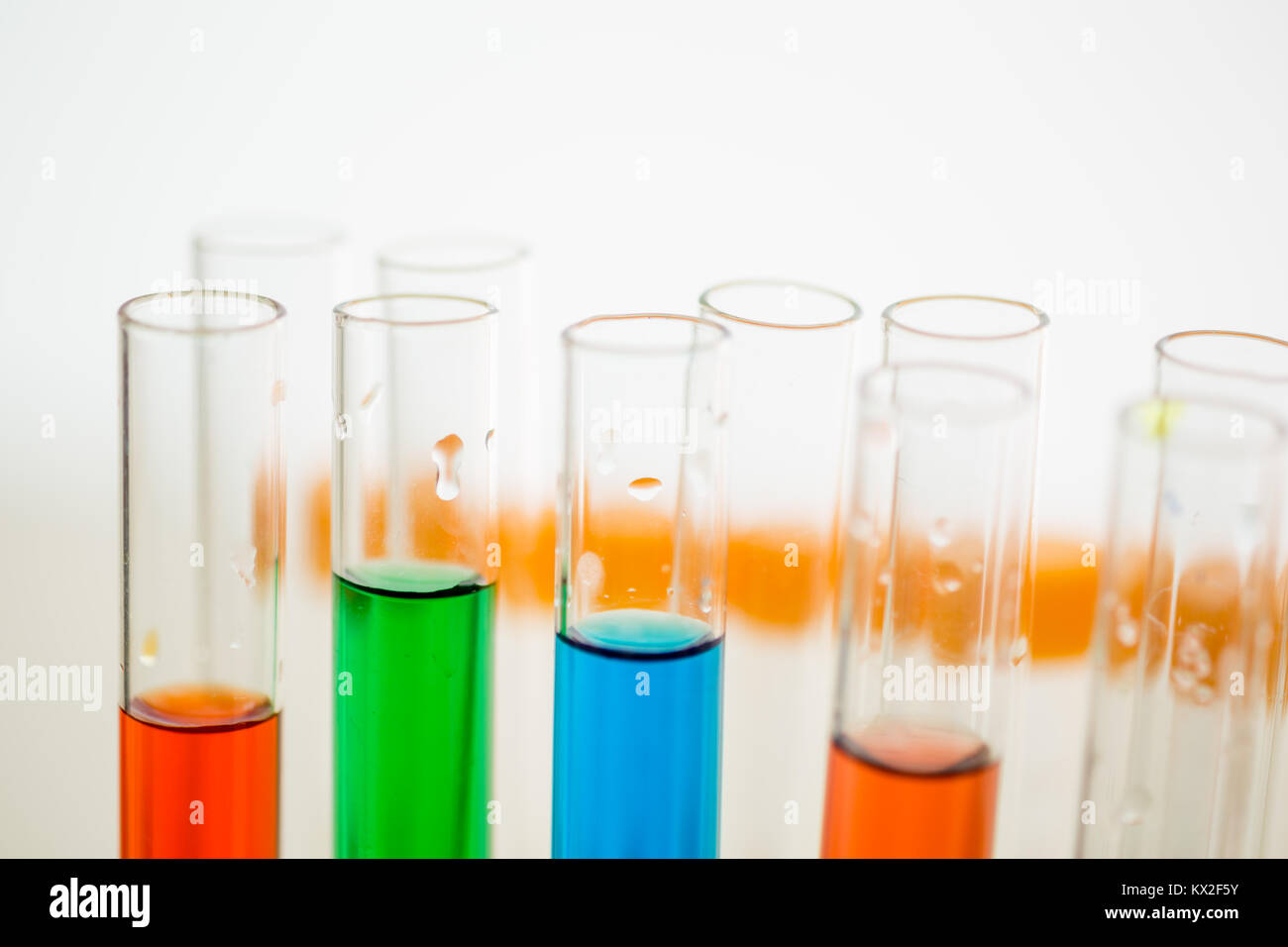 Rows of colorful test tubes on lab table Stock Photo - Alamy