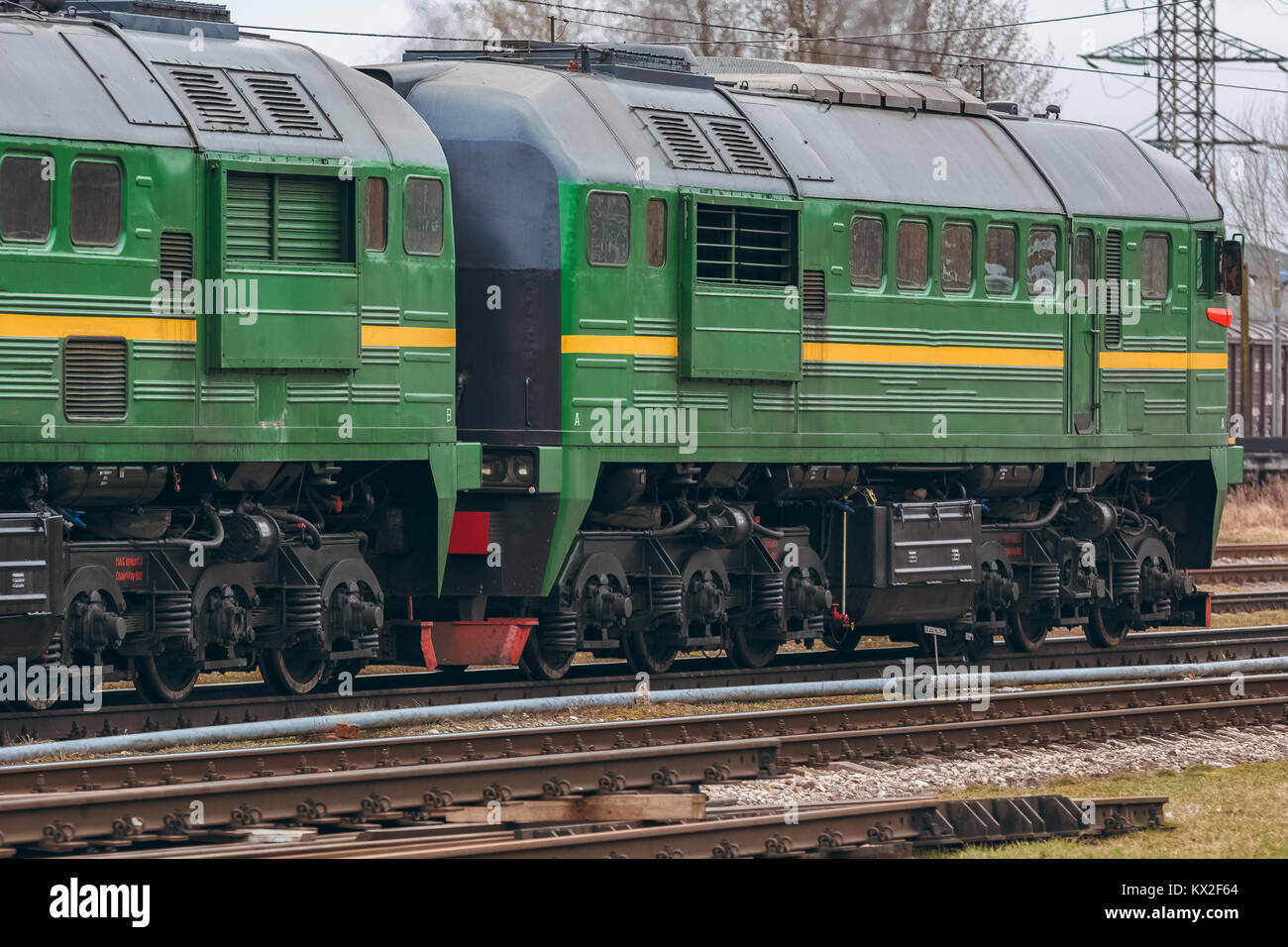 Green diesel cargo locomotive. Freight train in action Stock Photo - Alamy