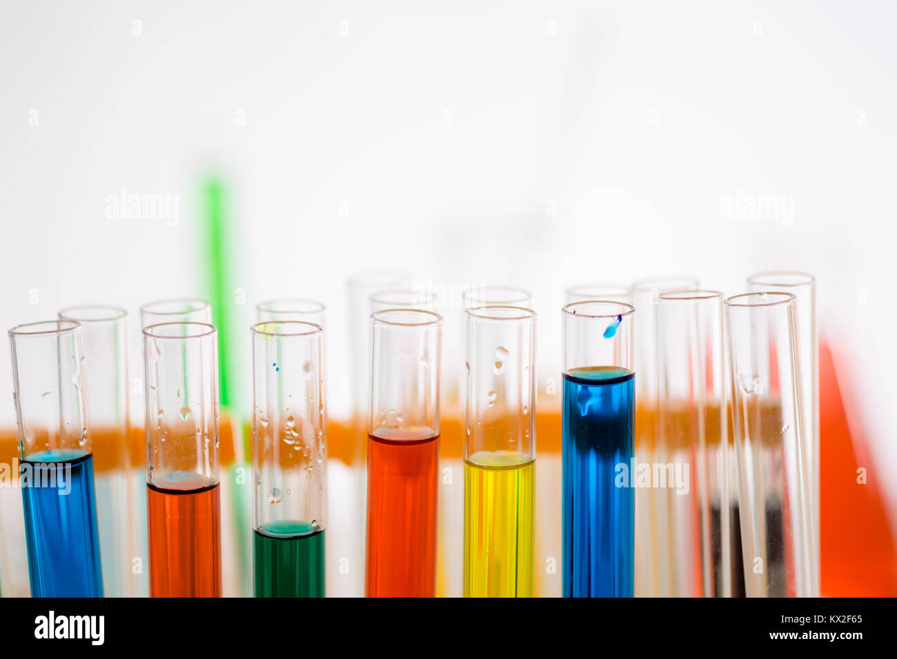 Rows of colorful test tubes on lab table Stock Photo - Alamy