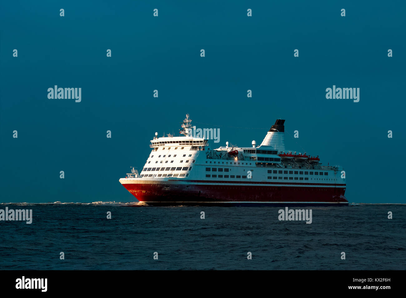 Red cruise liner. Passenger ship sailing from the sea in the morning ...