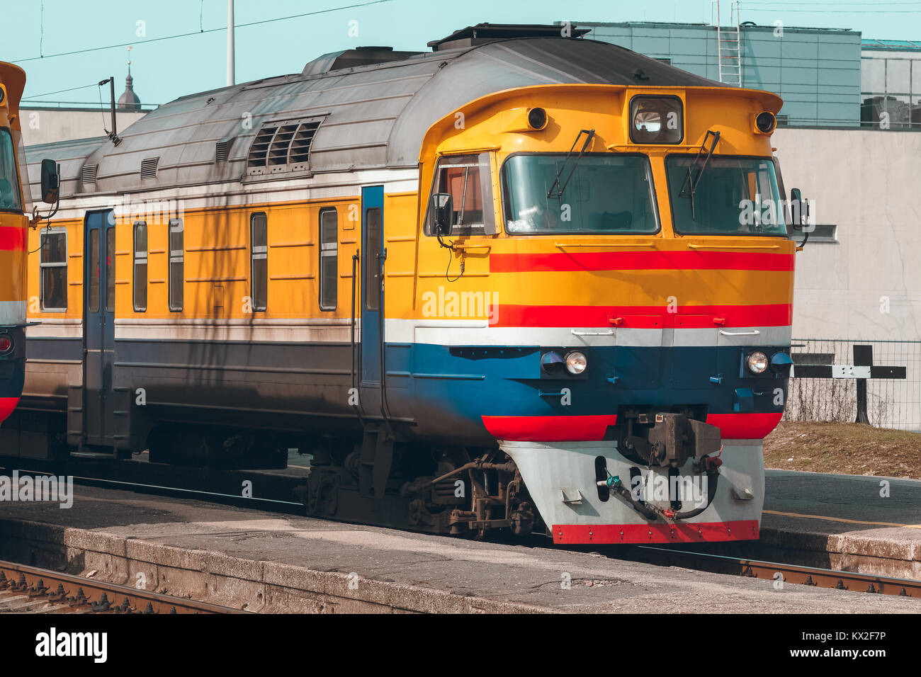 Old yellow passenger diesel train moving at the terminal Stock Photo ...