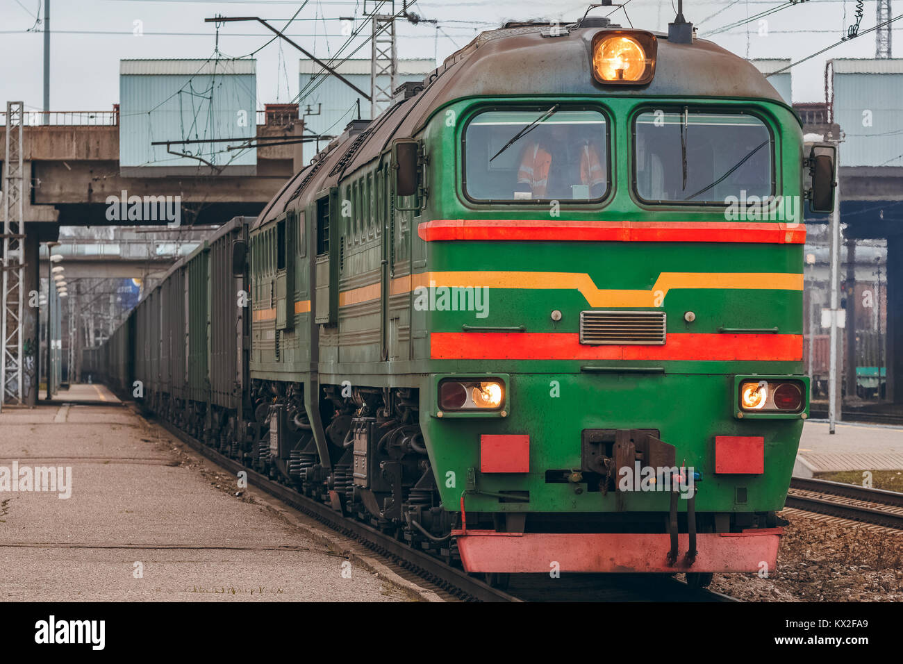 Green diesel cargo locomotive. Freight train in action Stock Photo - Alamy