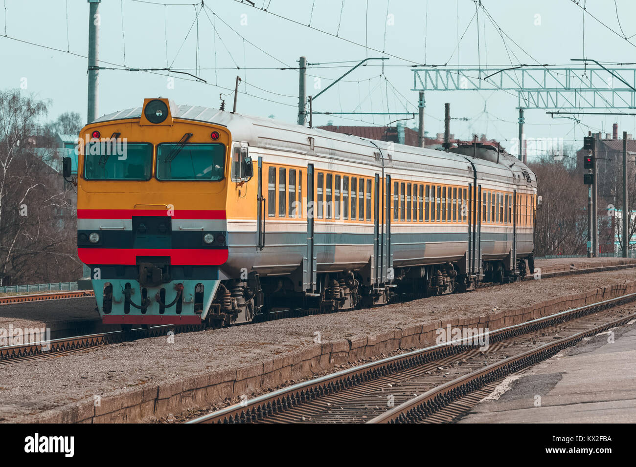 Old yellow passenger diesel train moving at the terminal Stock Photo ...