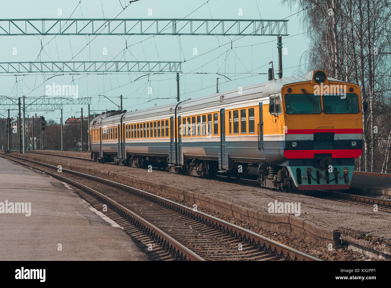 Old yellow passenger diesel train moving at the terminal Stock Photo ...