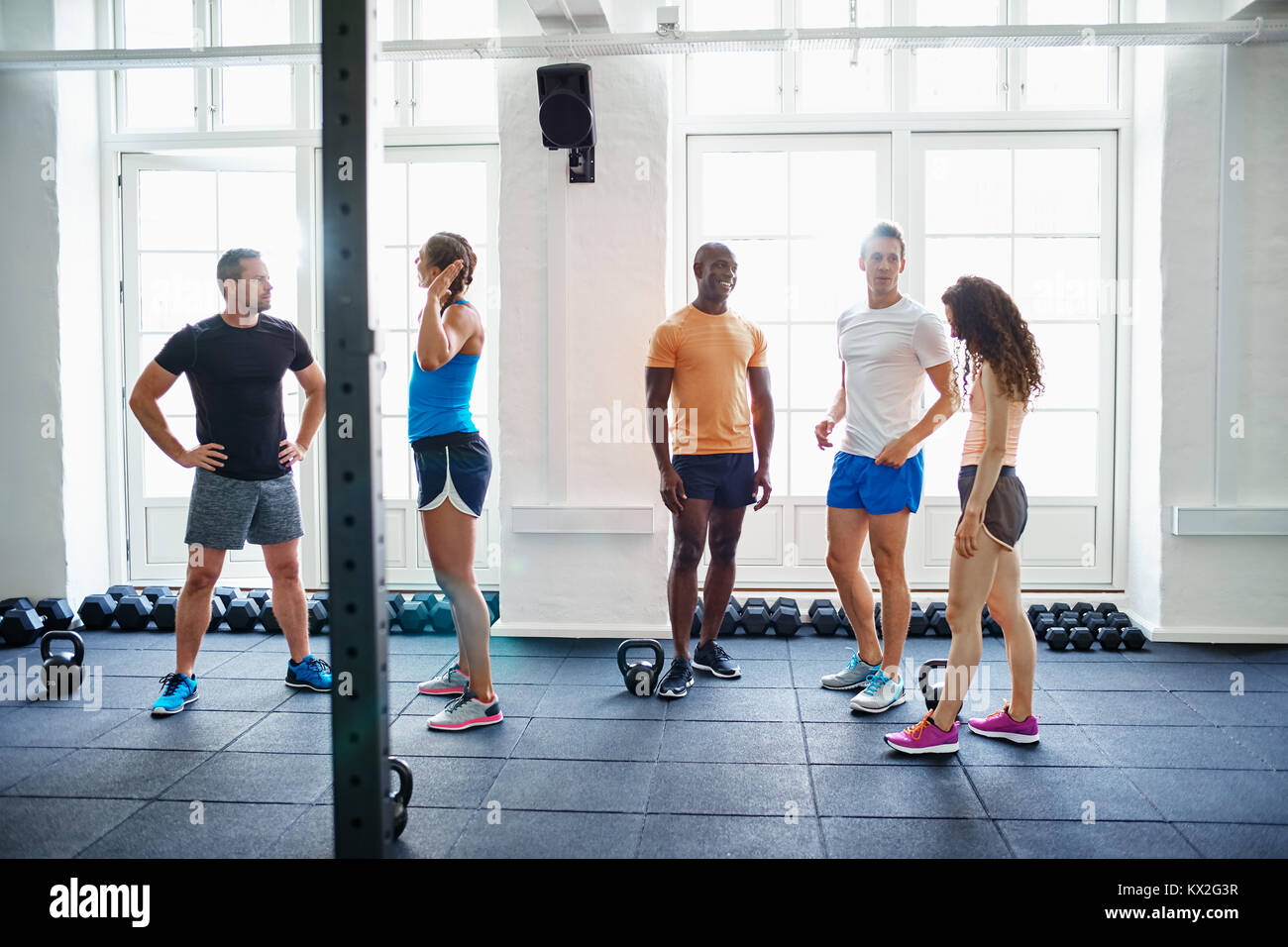 Diverse group of fit young people in sportswear standing in a gym ...