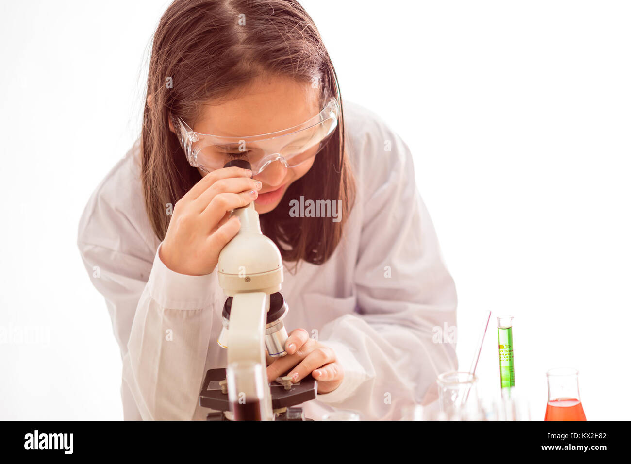 Asian American child scientist doing science experiment with microscope ...