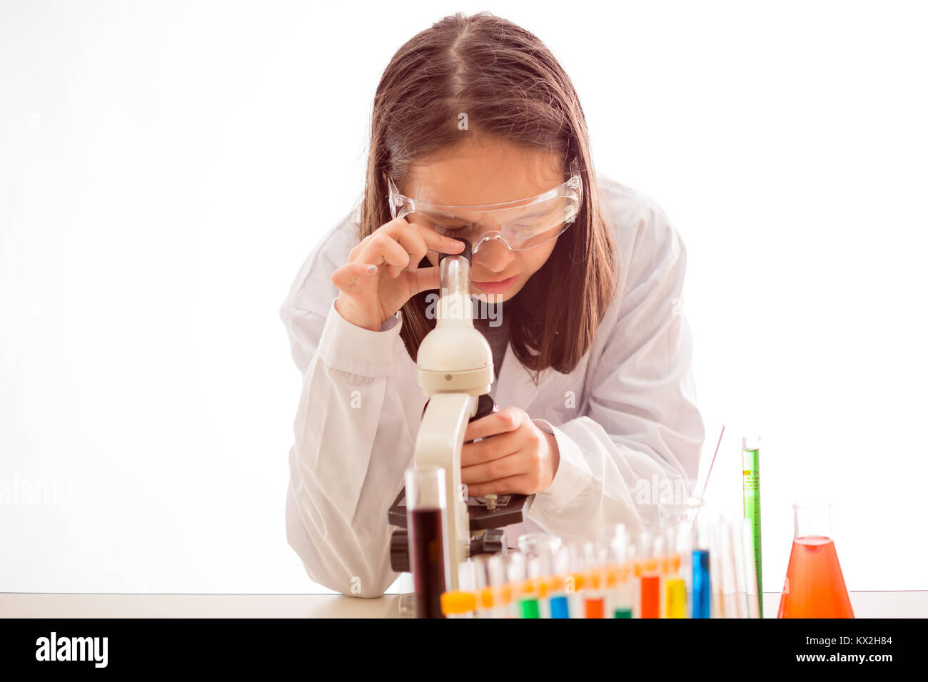 Asian American child scientist doing science experiment with microscope ...