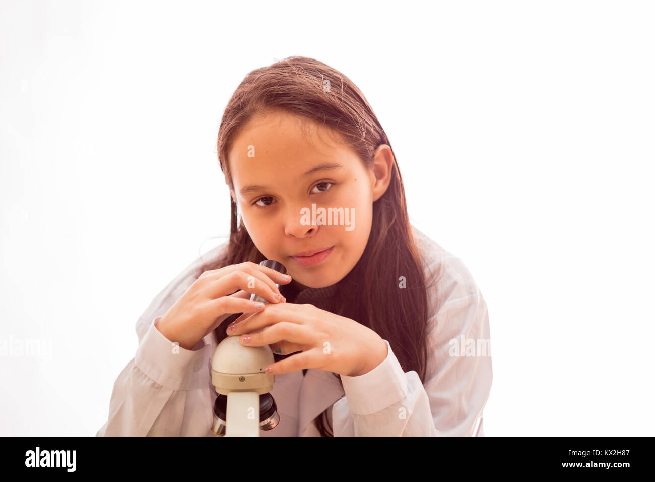Asian American child scientist doing science experiment with microscope ...