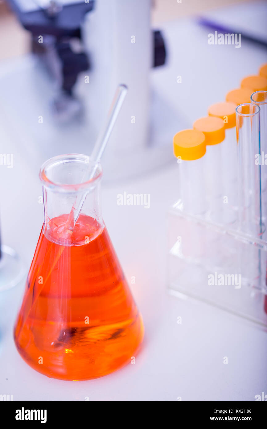 Test tubes, microscope, and beakers on lab table Stock Photo - Alamy