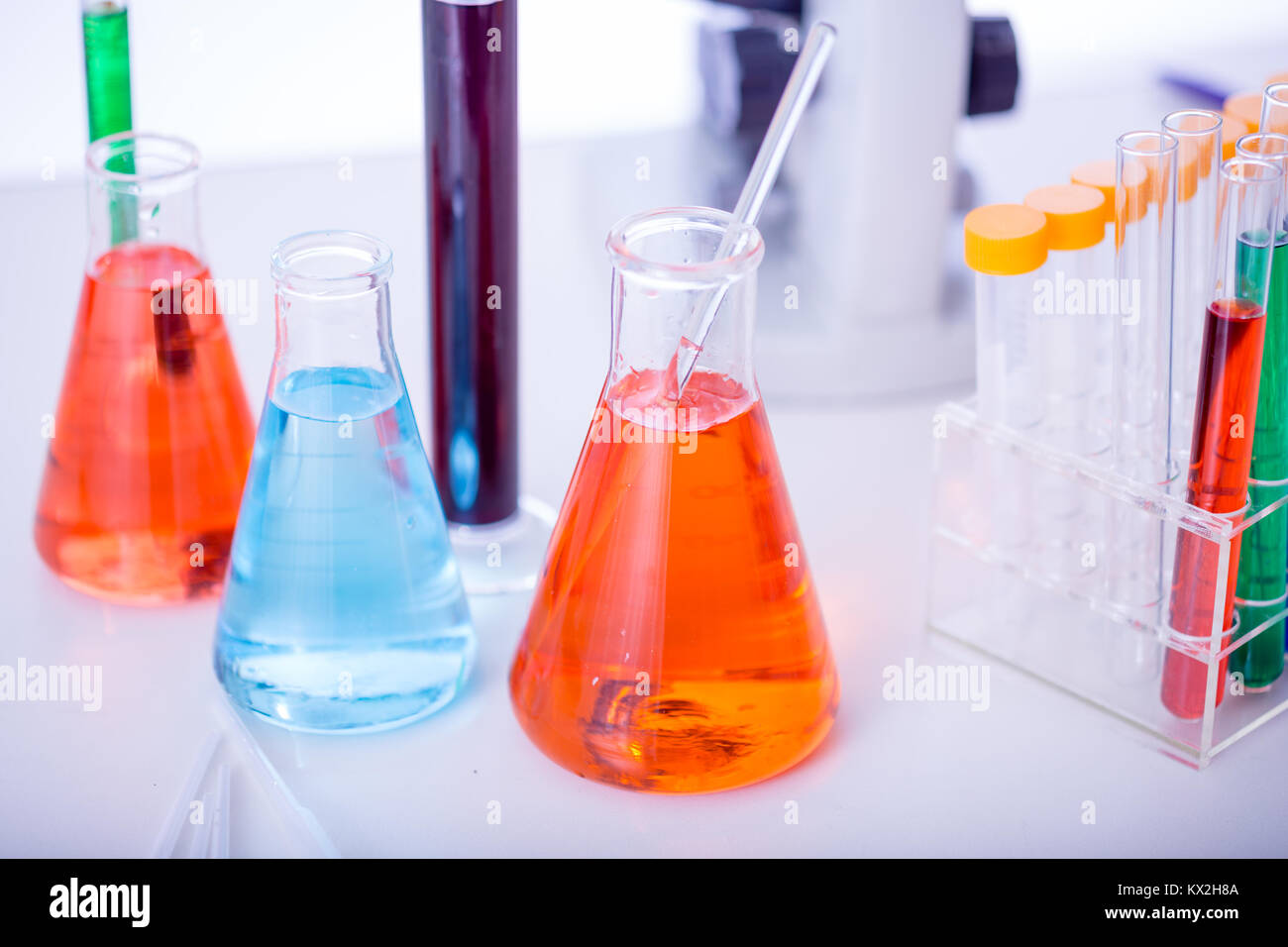 Test tubes, microscope, and beakers on lab table Stock Photo - Alamy