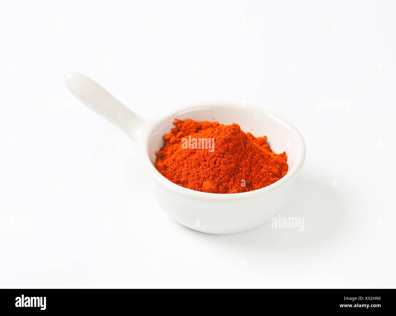 Ground Red Pepper in small white dish Stock Photo - Alamy