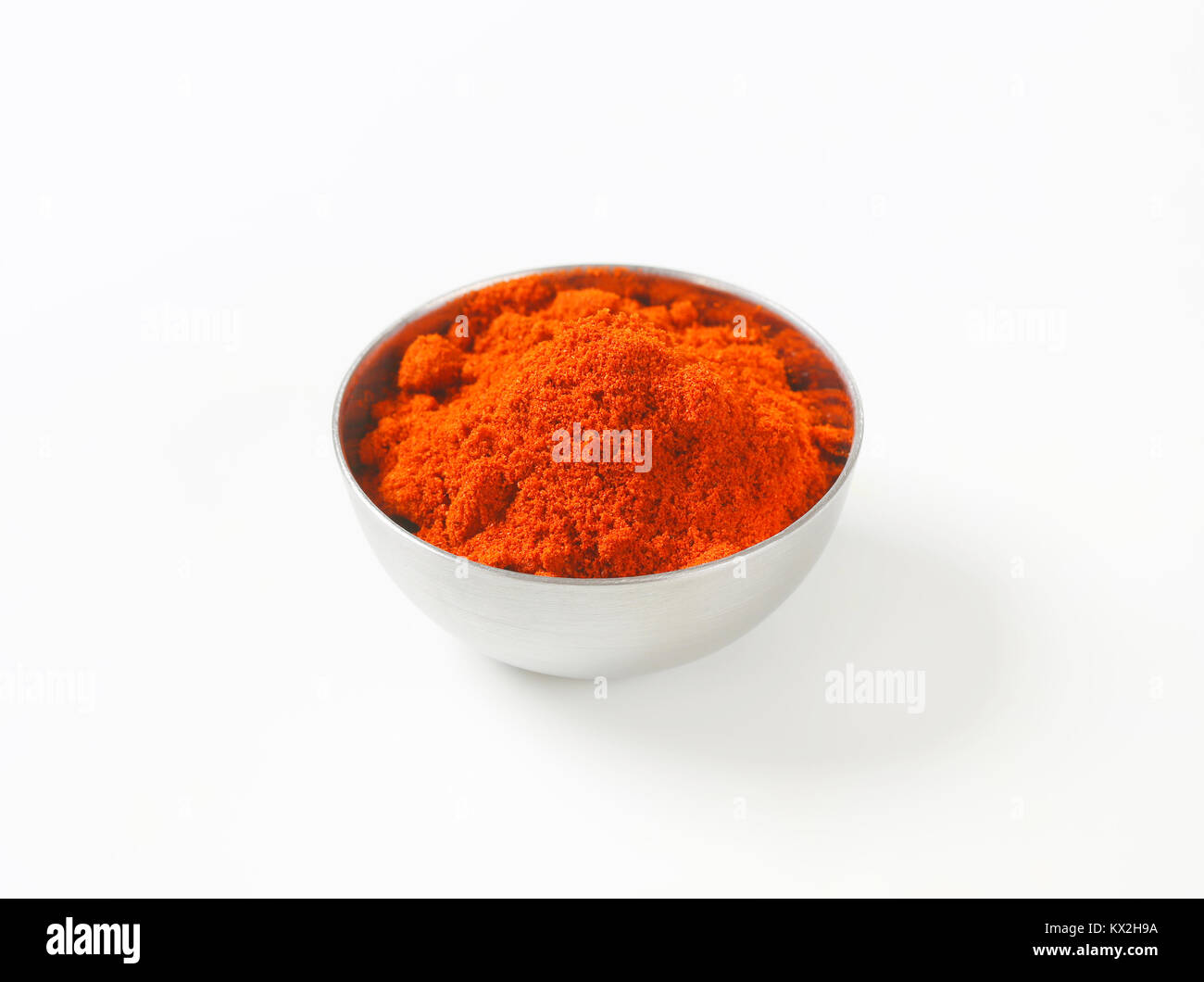 Ground red pepper in metal bowl Stock Photo - Alamy