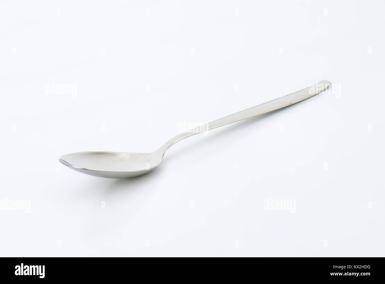 Empty metal table spoon on white background Stock Photo - Alamy