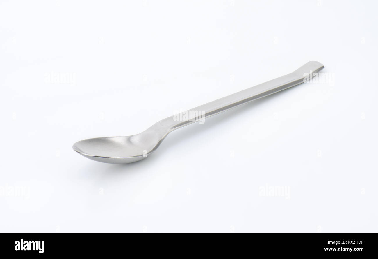 Small empty metal spoon on white background Stock Photo - Alamy