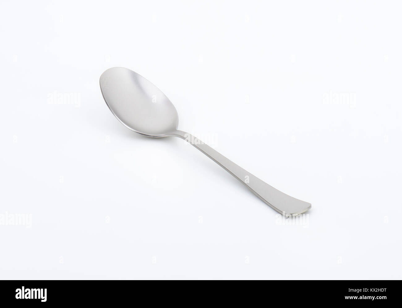 Small empty metal spoon on white background Stock Photo - Alamy