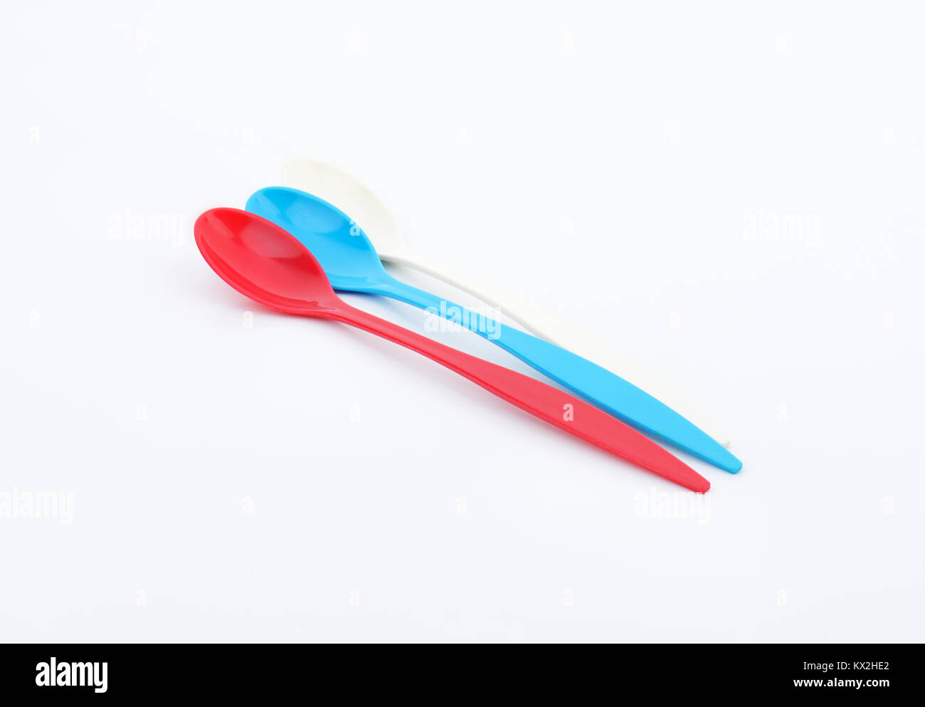 Three empty long plastic spoons - red, blue and white Stock Photo - Alamy