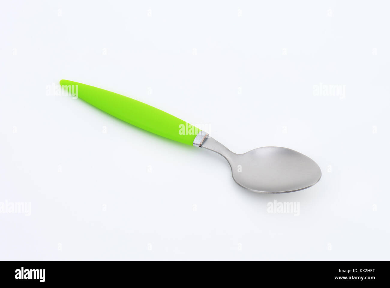 Empty teaspoon with green plastic handle on white background Stock ...