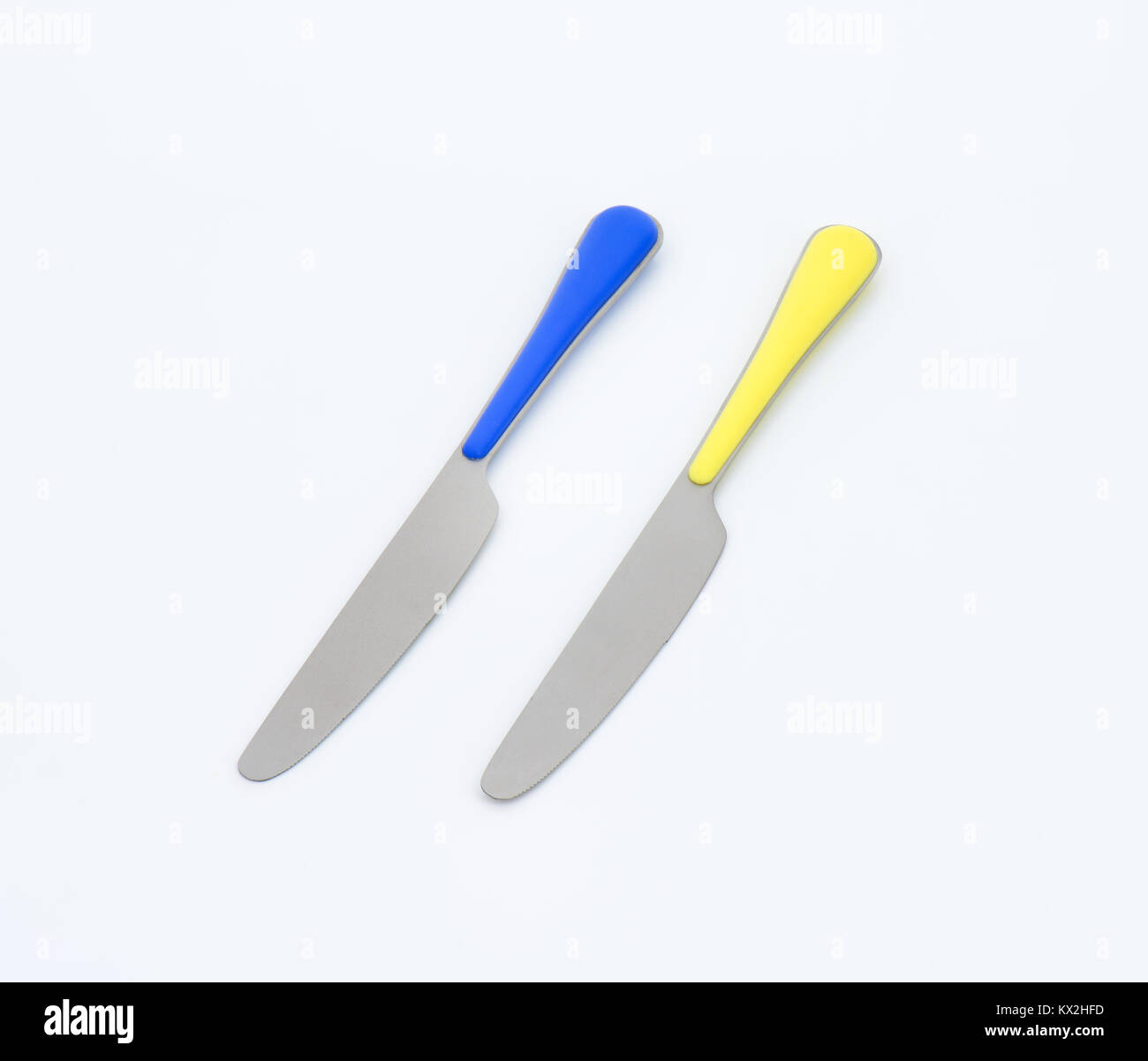 Two table knives, one with blue handle, the other one with yellow ...