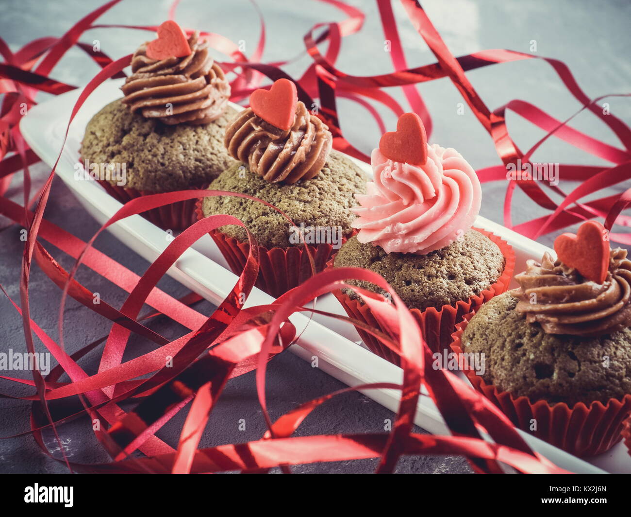 Fresh cupcakes decorated with cream and hearts Stock Photo - Alamy