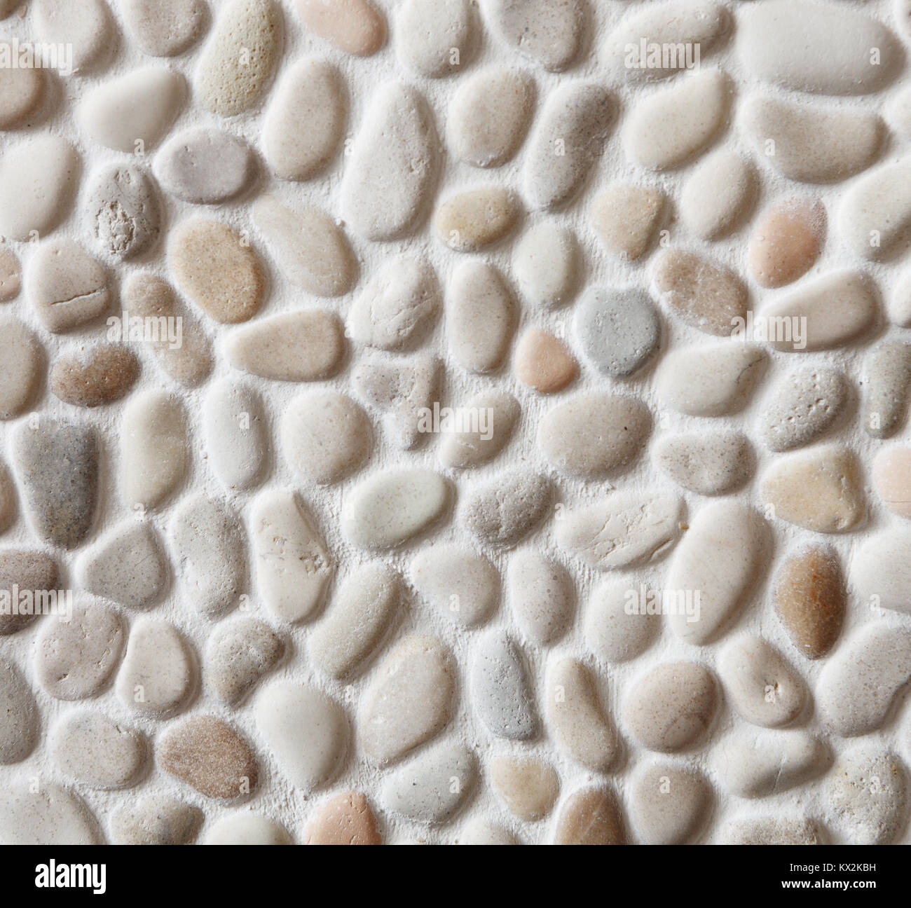 Fragment of the wall is decorated with a small sea pebbles Stock Photo ...