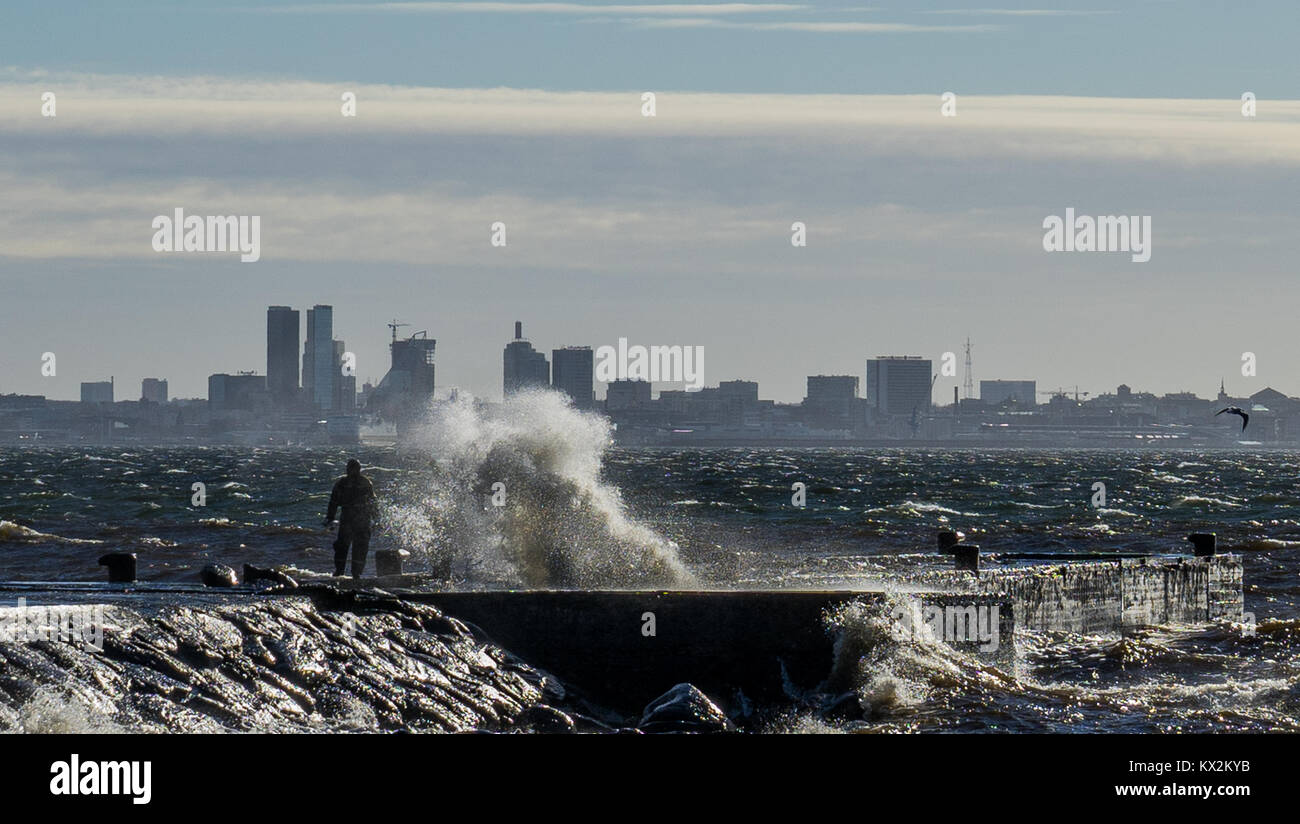 Storm on sea. Estonian capital Tallinn at background, with people Stock ...