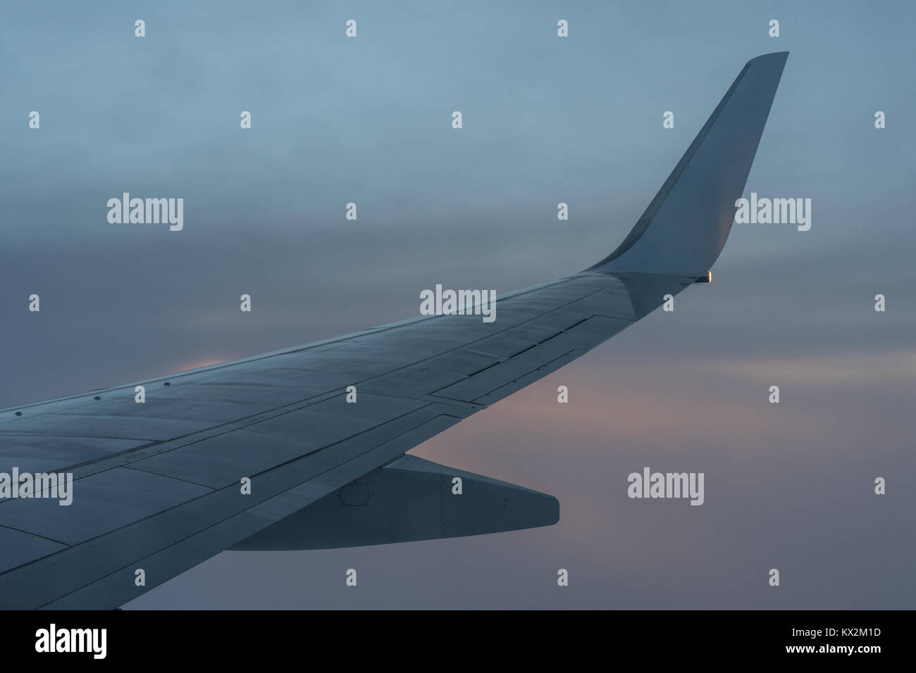 View from an airplane flying high above the clouds into the sunset ...