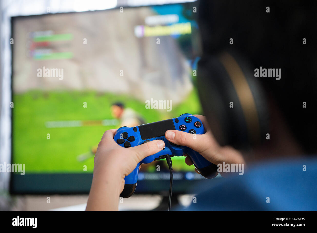 A young boy plays on a gaming console Stock Photo - Alamy