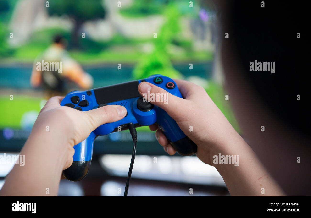 A young boy plays on a gaming console Stock Photo - Alamy