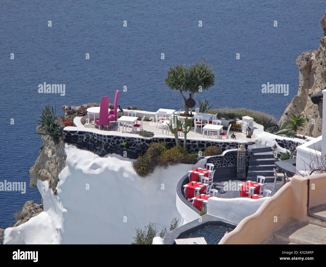 Stunning outdoor seating at the terrace over the caldera on vibrant ...