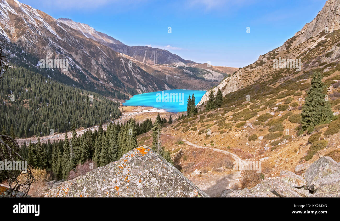 Game of shadows on the emerald Big Almaty lake in autumn season Stock ...