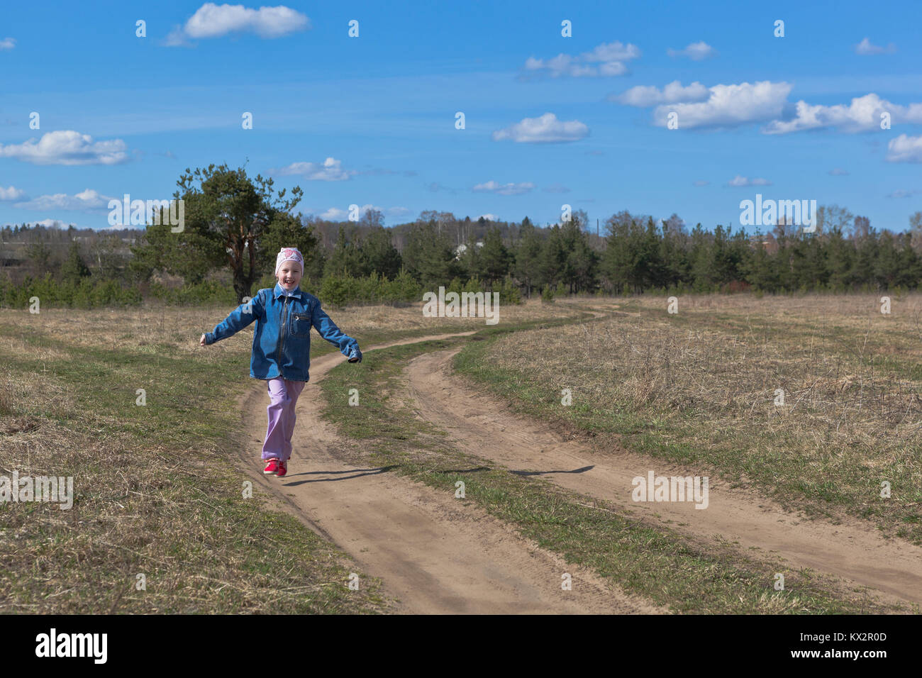 Girl running through field at distance hi-res stock photography and ...