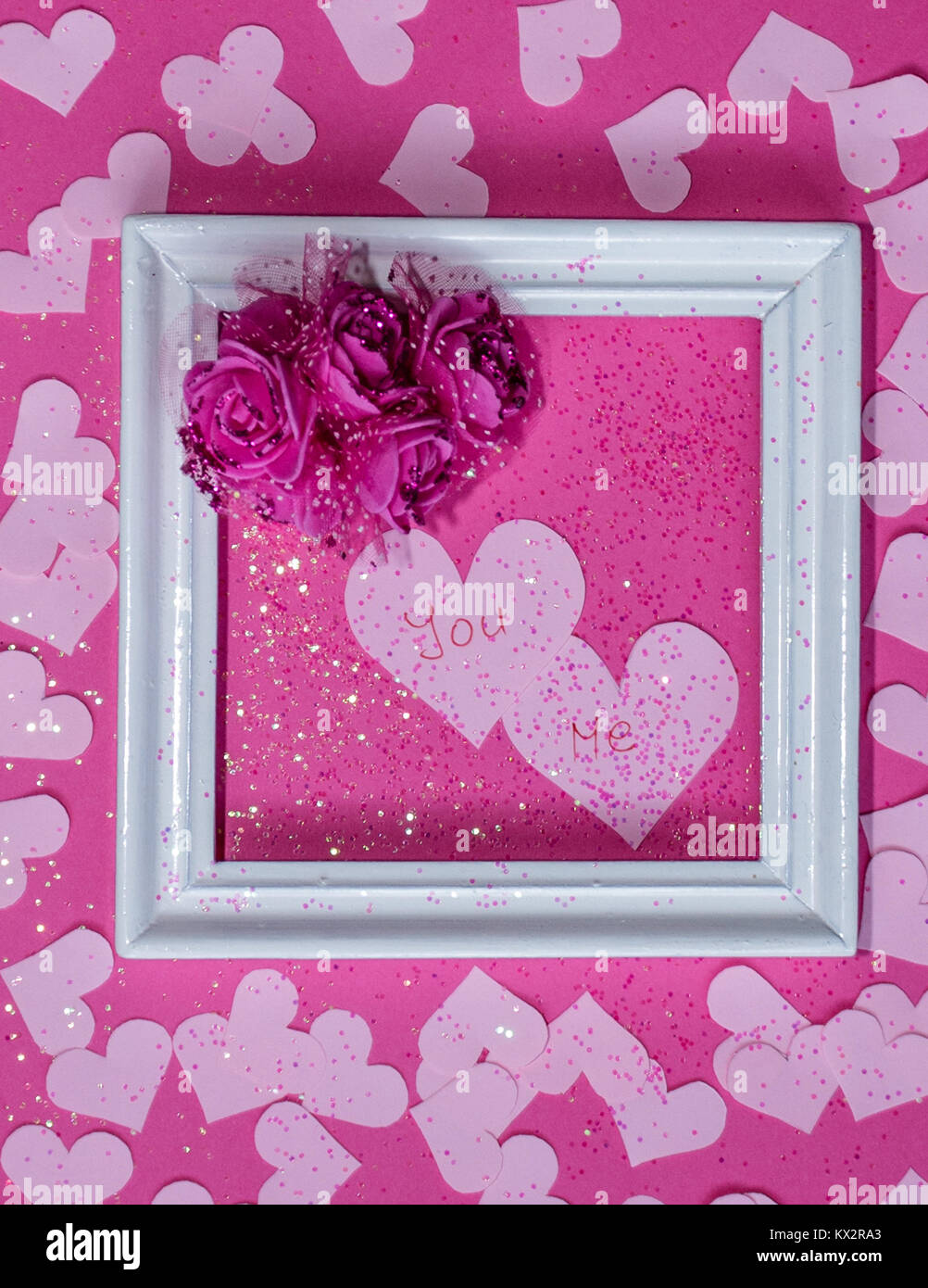 Two pink harts that say you and me are in the frame with flowers and ...