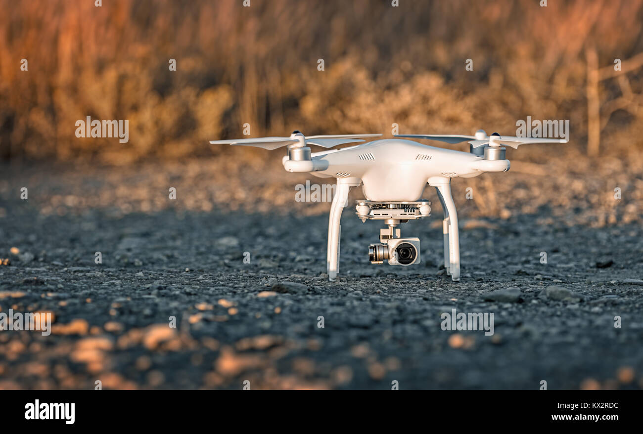 White drone quad copter with high resolution digital camera at the ...