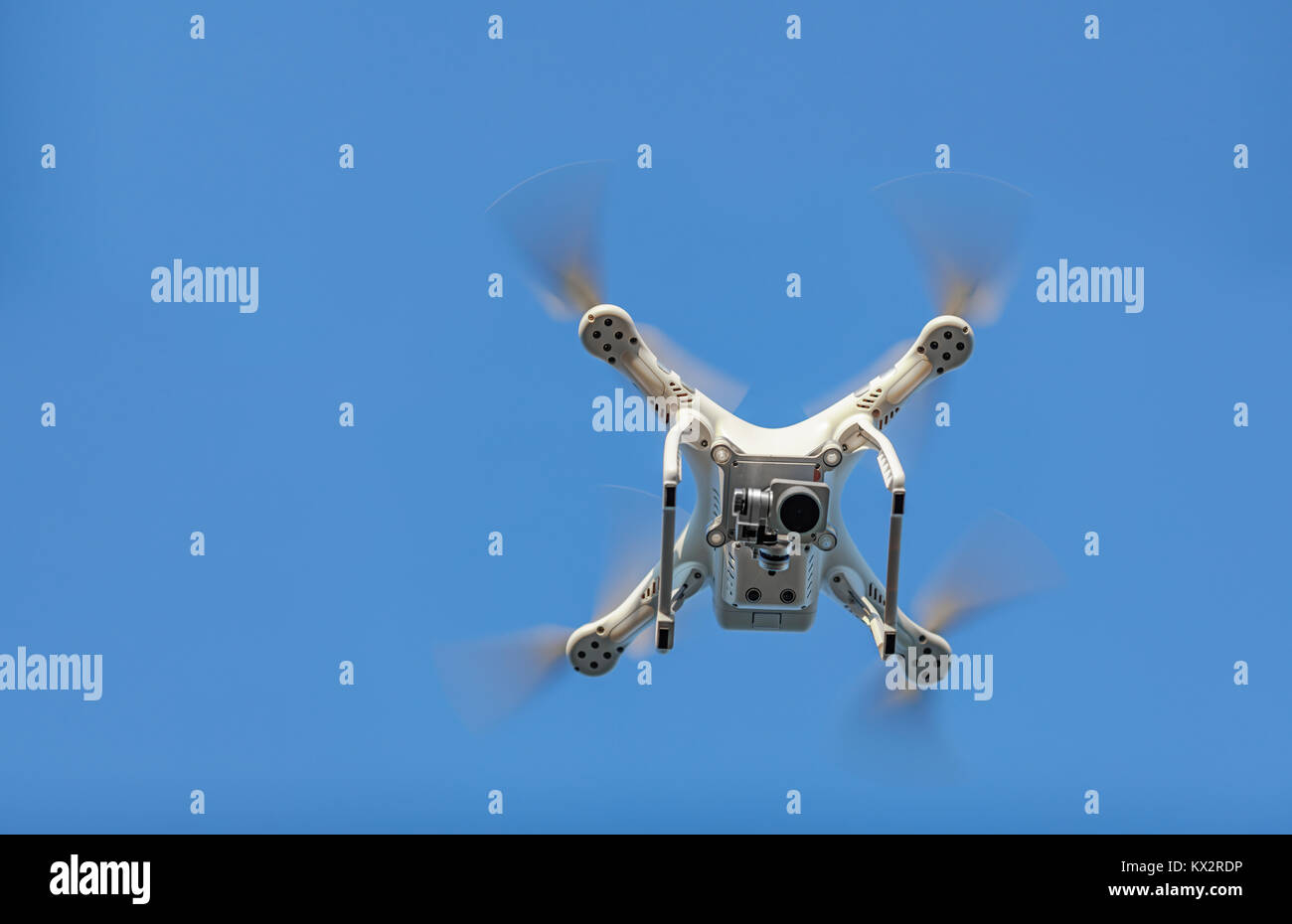 Drone is watching you. White drone quad copter with high resolution ...