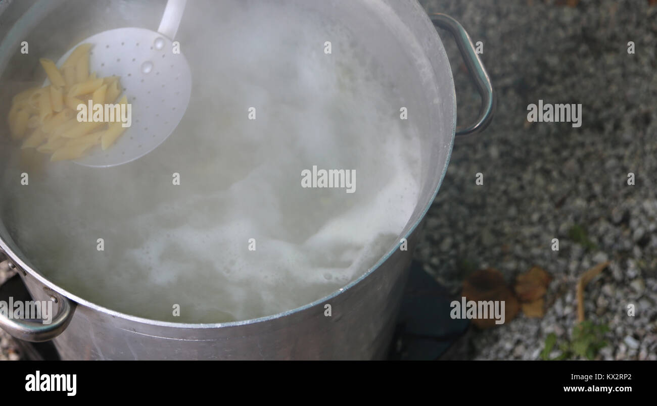 big pot with pasta in the kitchen camp Stock Photo - Alamy