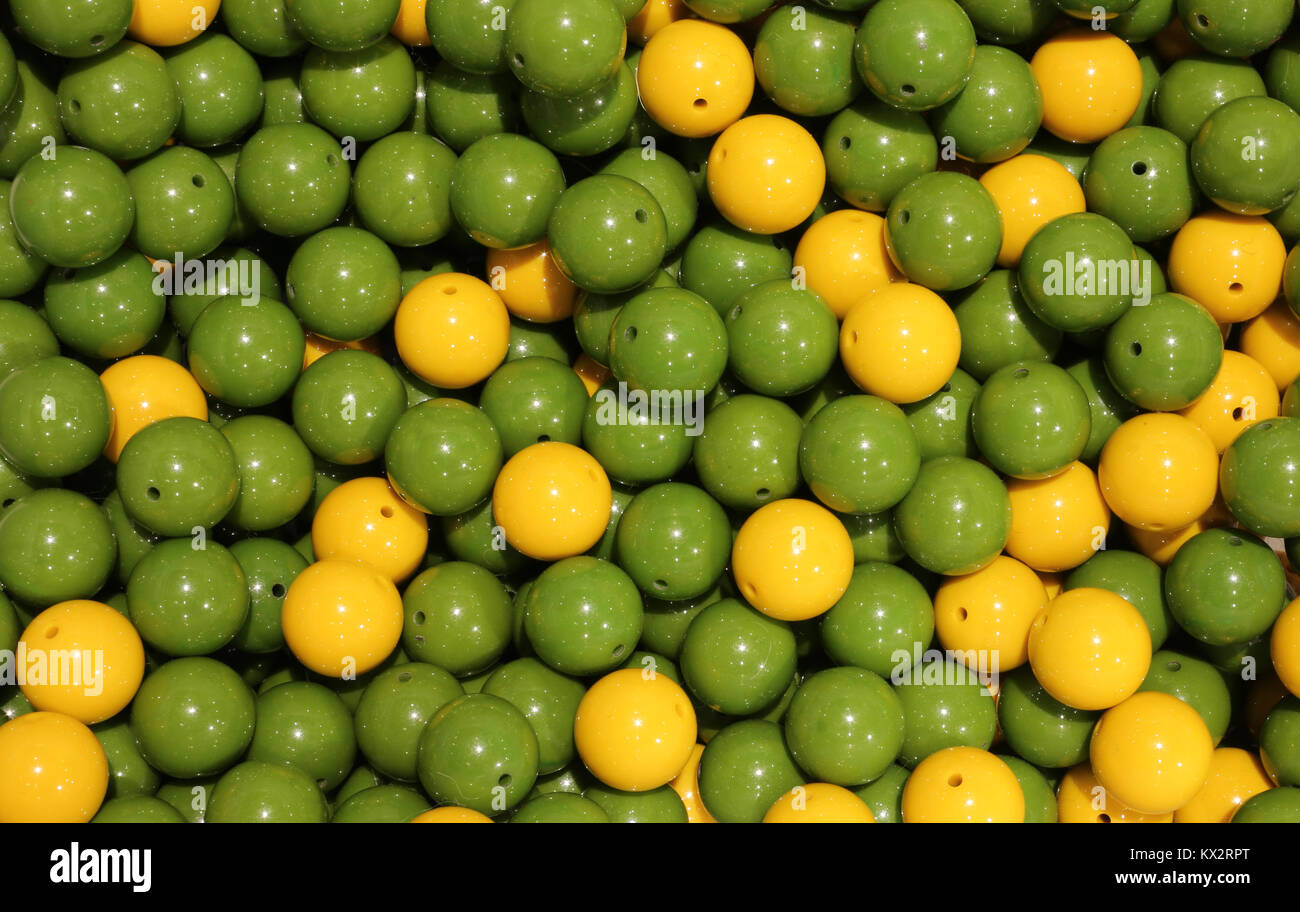 many little green and yellow balls to make a necklace Stock Photo - Alamy