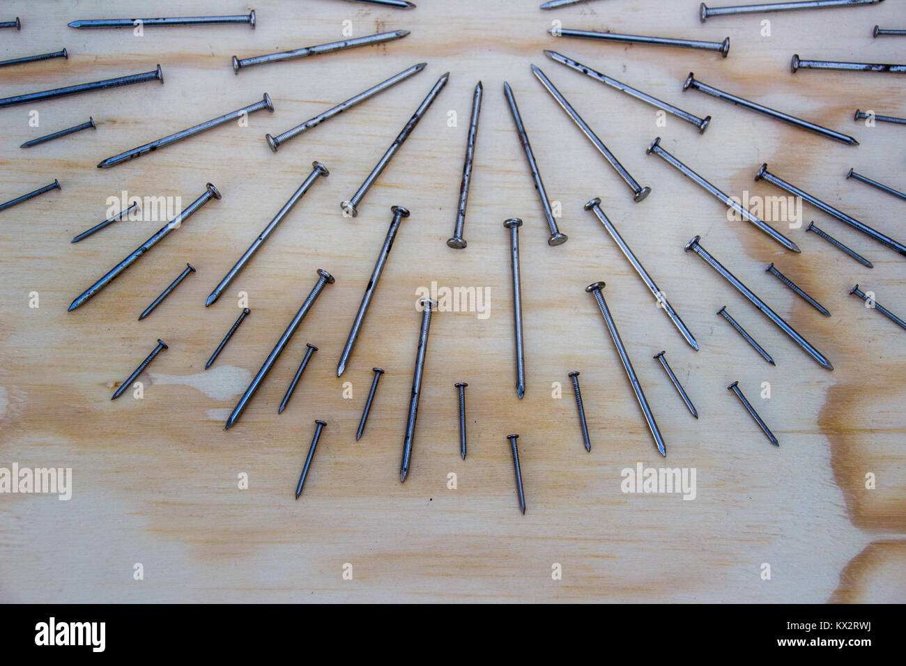 Photograph of some Metal nails in geometric composition Stock Photo - Alamy