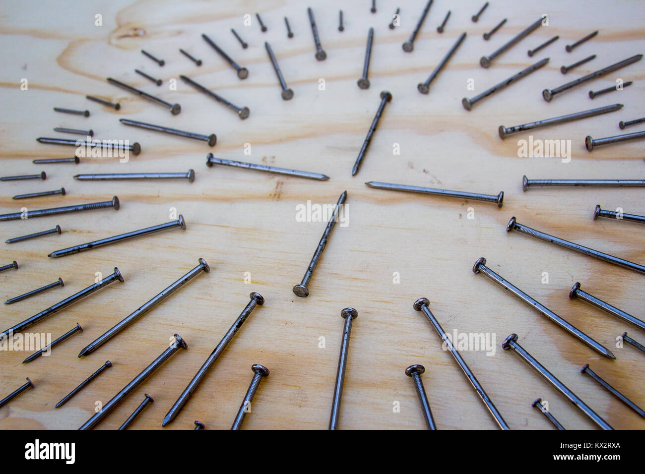 Photograph of some Metal nails in geometric composition and cross ...