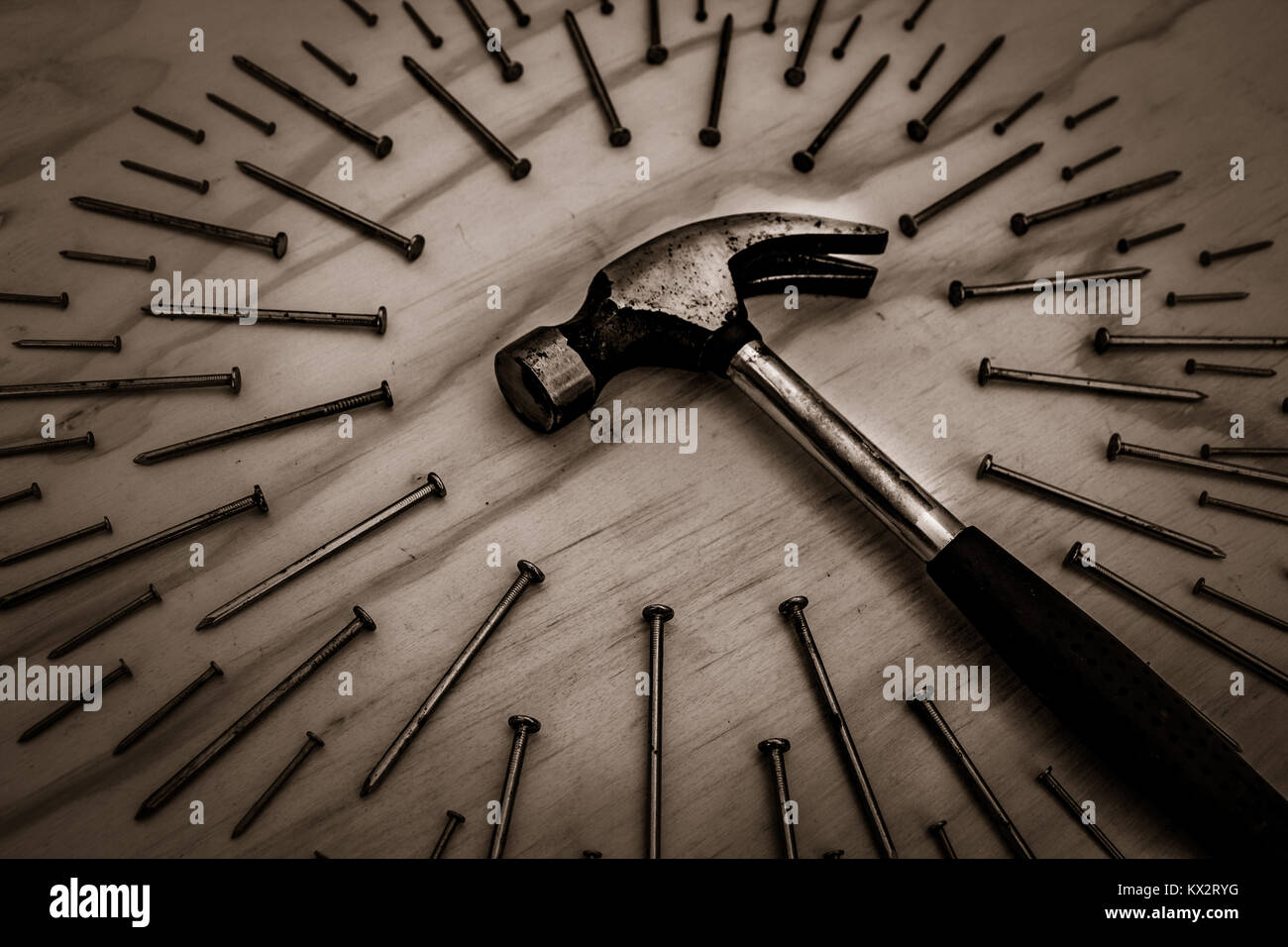 Photograph of a hammer and nails on wood background Stock Photo - Alamy