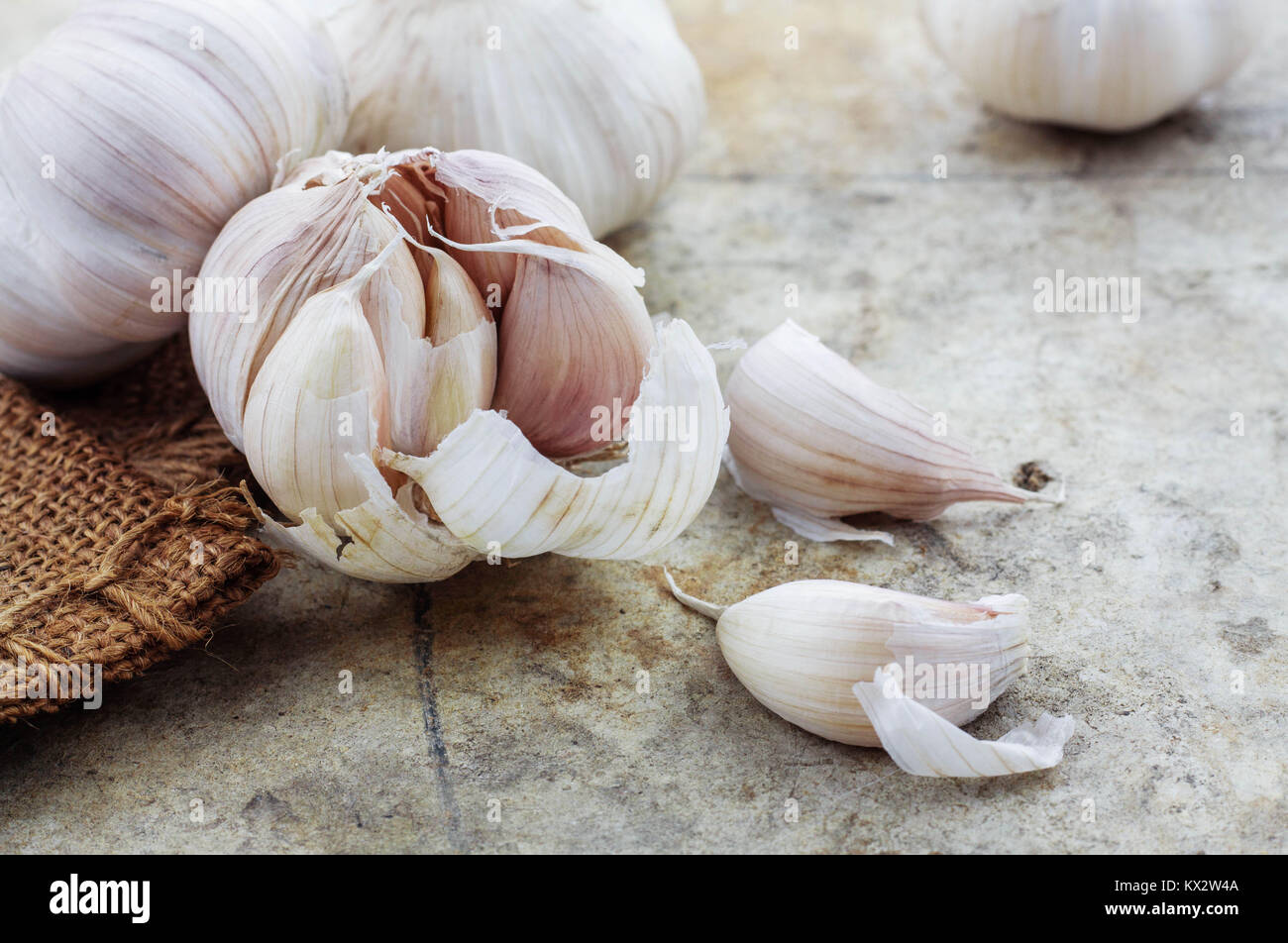 Garlic on a sack of cement floor Stock Photo - Alamy
