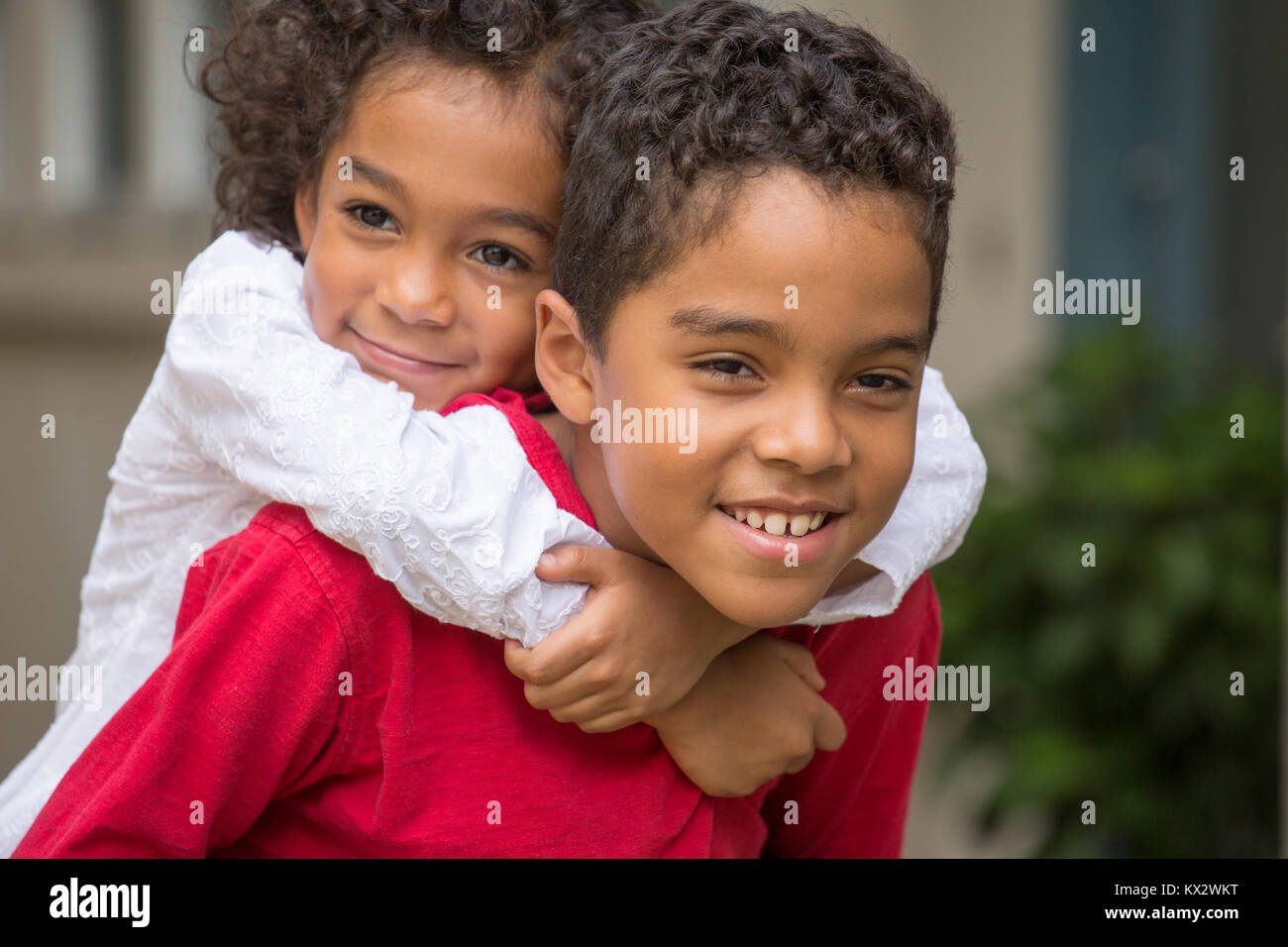 Hispanic brother and sister playing Stock Photo - Alamy