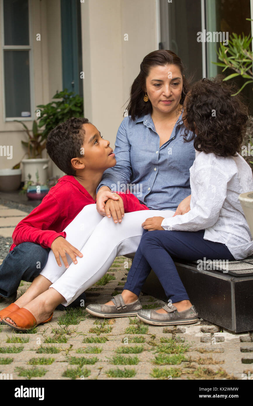 Hispanic mother talking with her childeren Stock Photo - Alamy