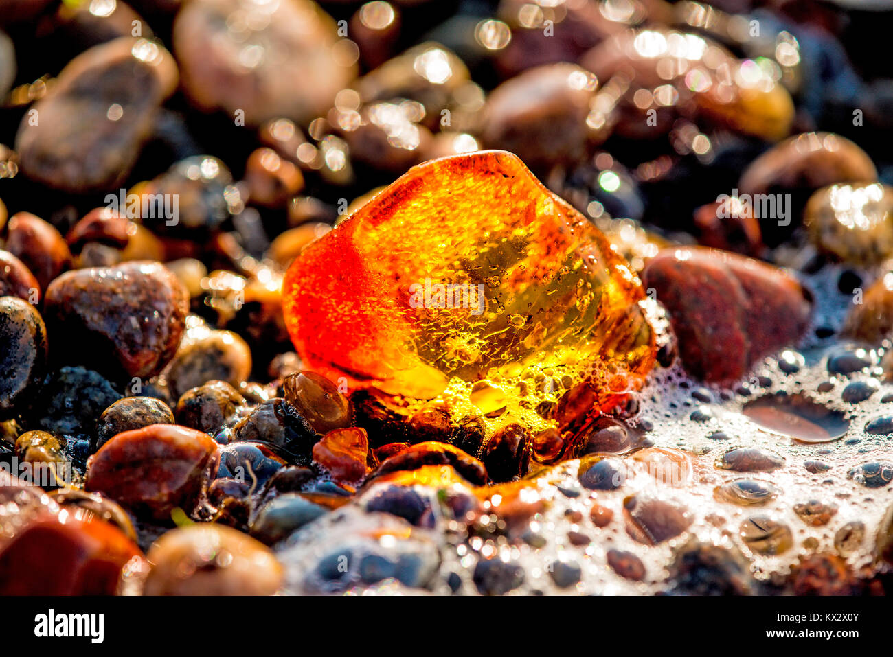Amber on a beach of the Baltic Sea in the surf Stock Photo - Alamy