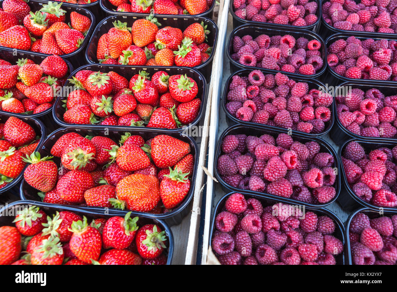Strawberries and raspberries displayed in plastic boxes Stock Photo - Alamy
