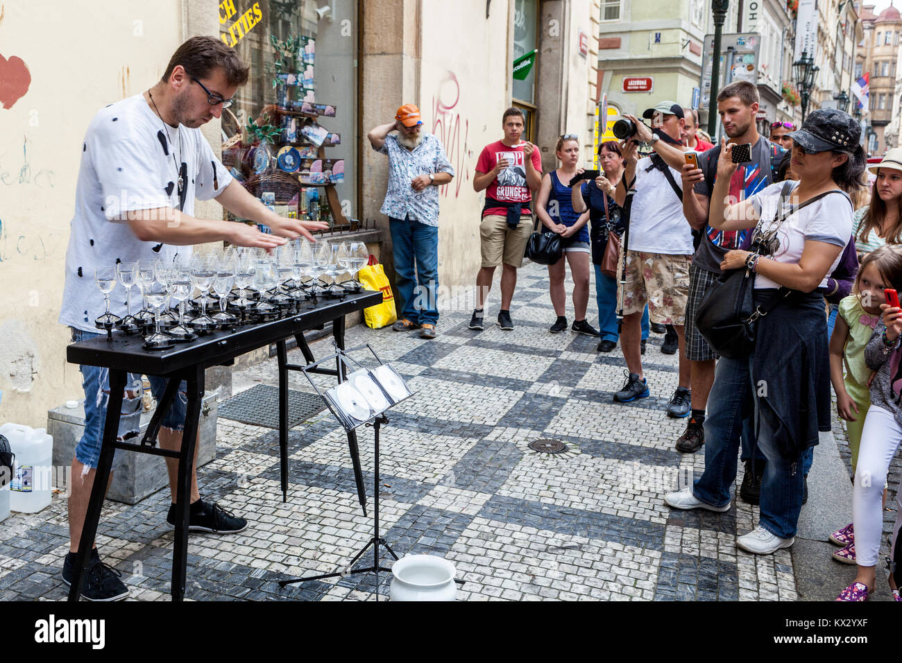 Prague street performer plays on glasses in front of tourists, Musical ...