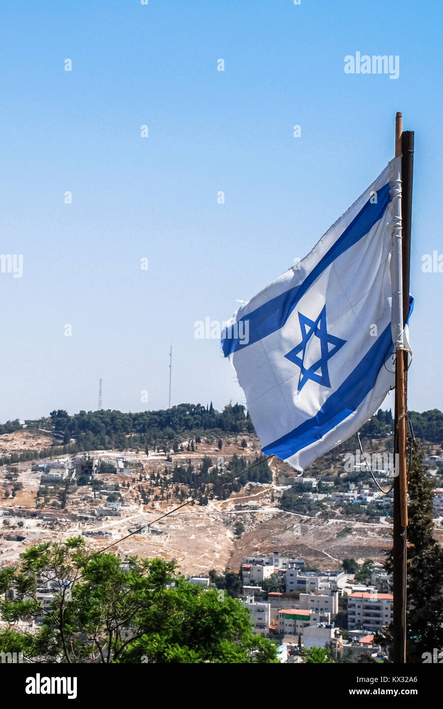 Vertical picture of Israel flag on the top of the hill close to the Old ...