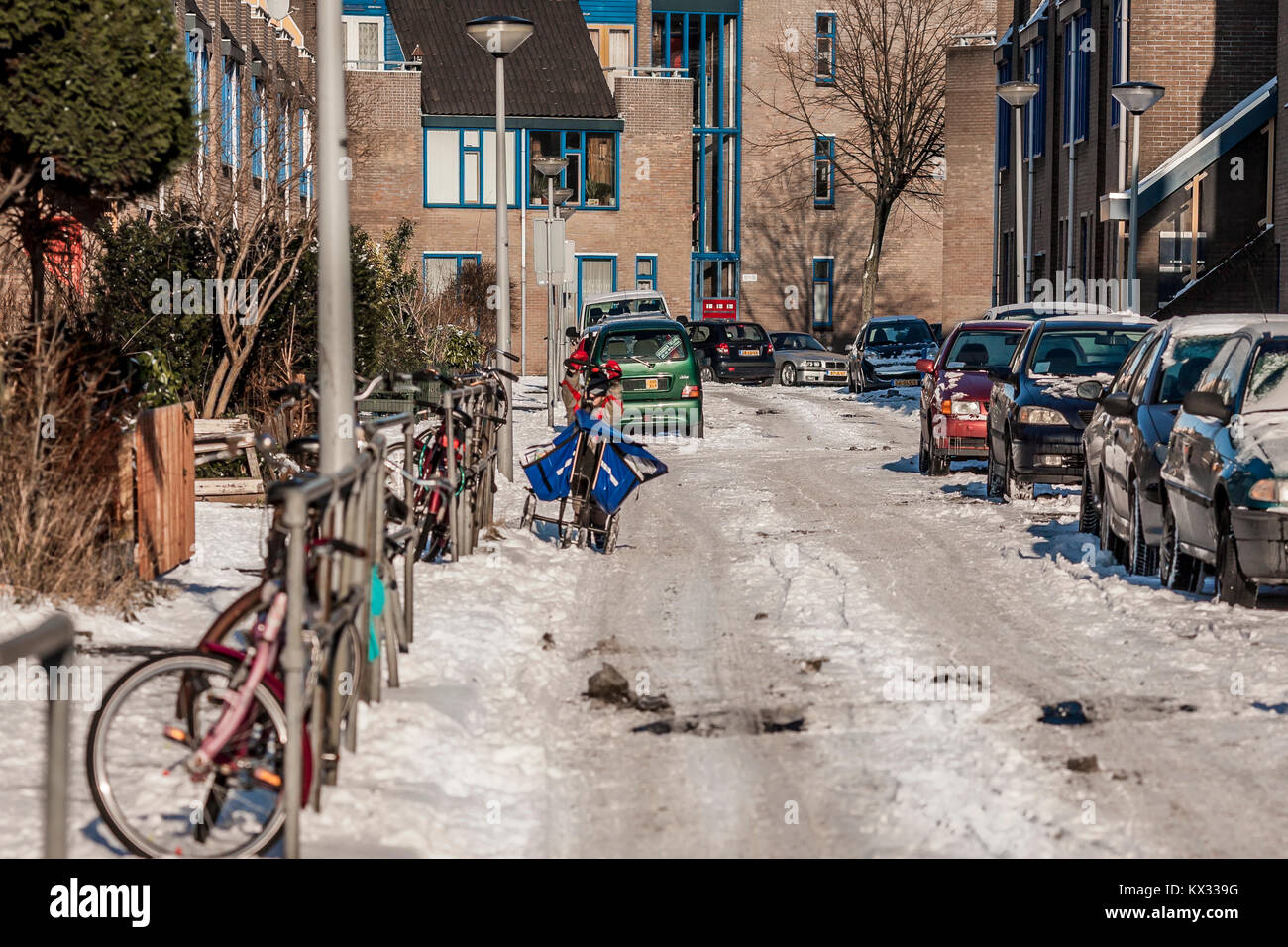 Amsterdam street in the winter with bicycles and parked cars Stock ...