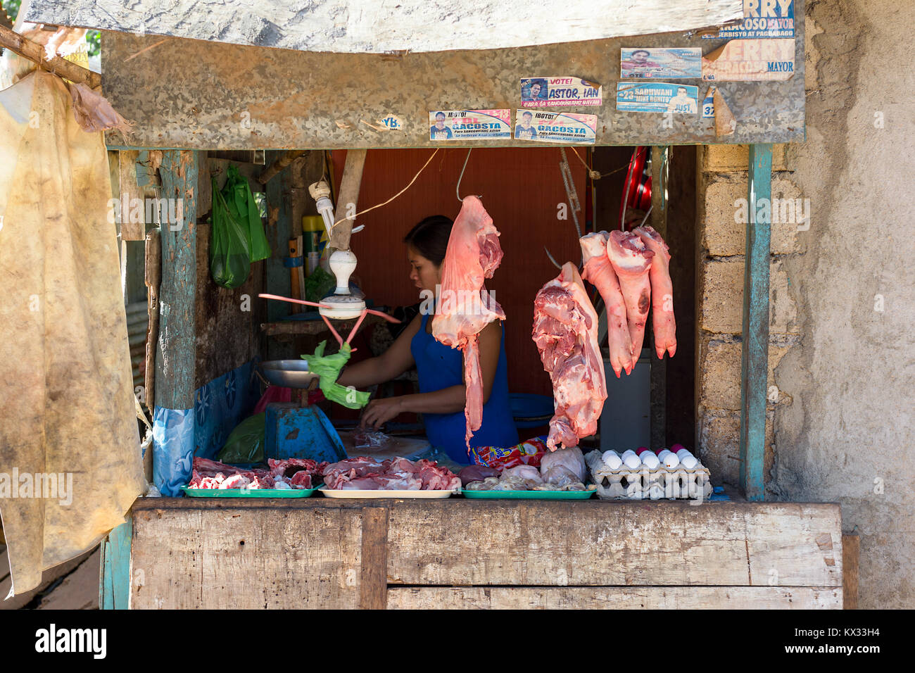 An open air basic butchers meat shop open from the side on a locals ...