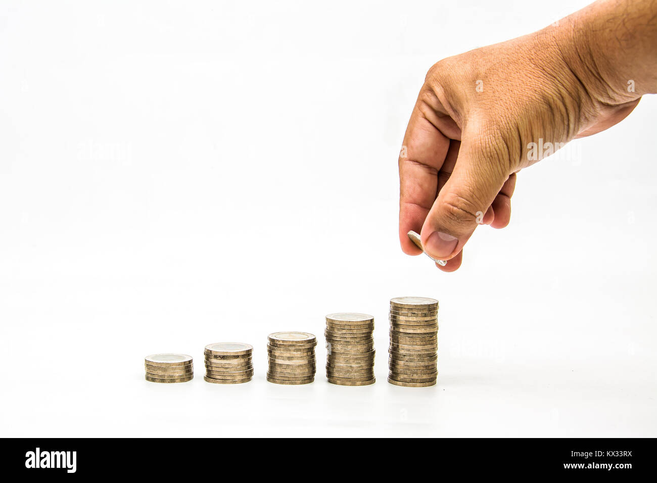 coin stacks with hand on white background Stock Photo - Alamy